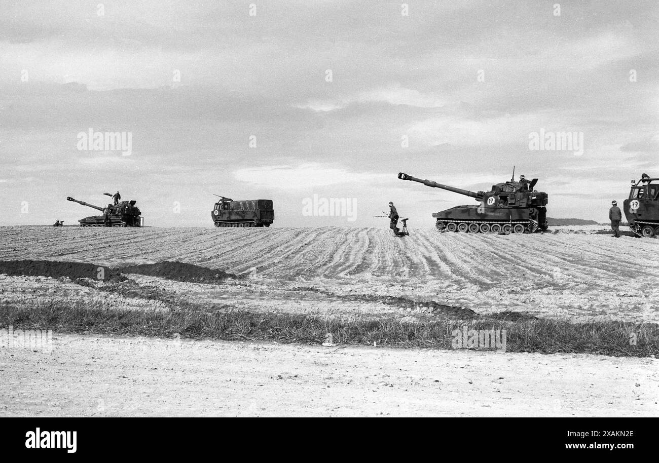 Tanks (155mm howitzers) practicing on a harvested grain field, autumn ...