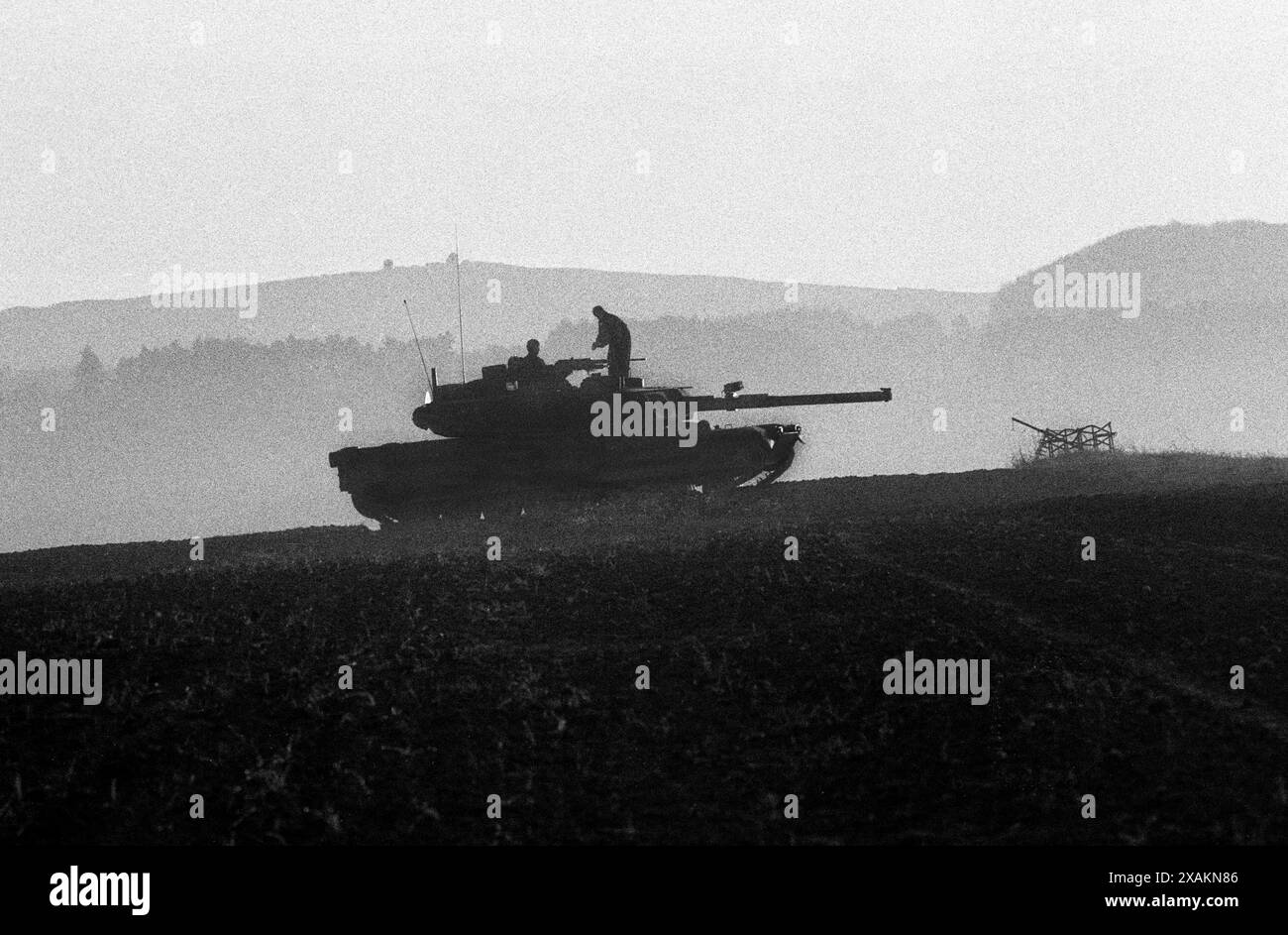 US soldiers cleaning machine gun on tank, in the background Rhön ...