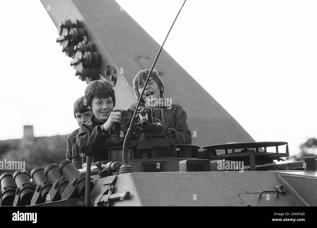 Children play on armored vehicles with machine guns, military show of ...