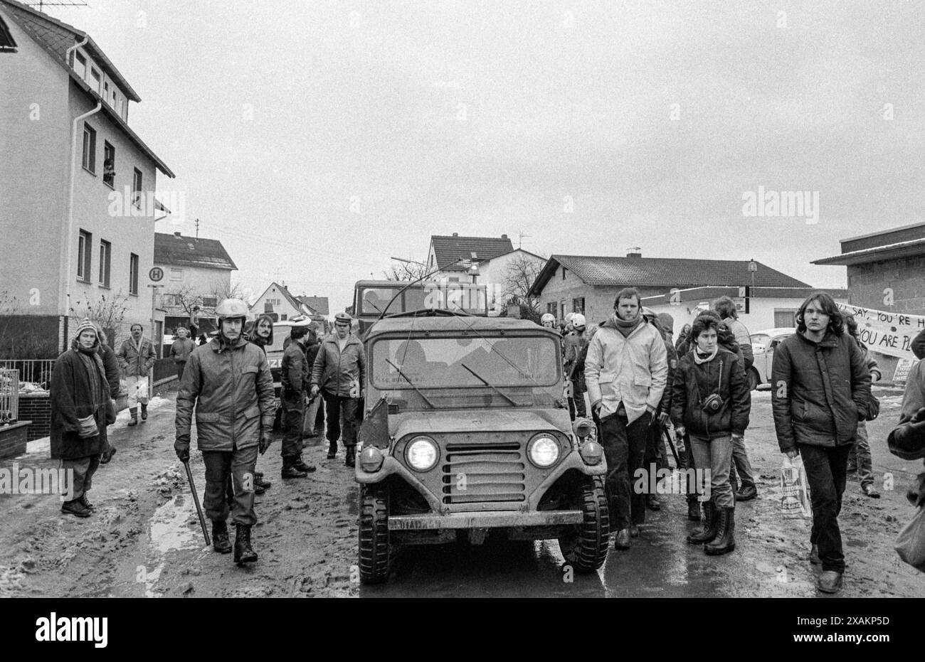 Police accompany a US military maneuver convoy with batons to prevent ...