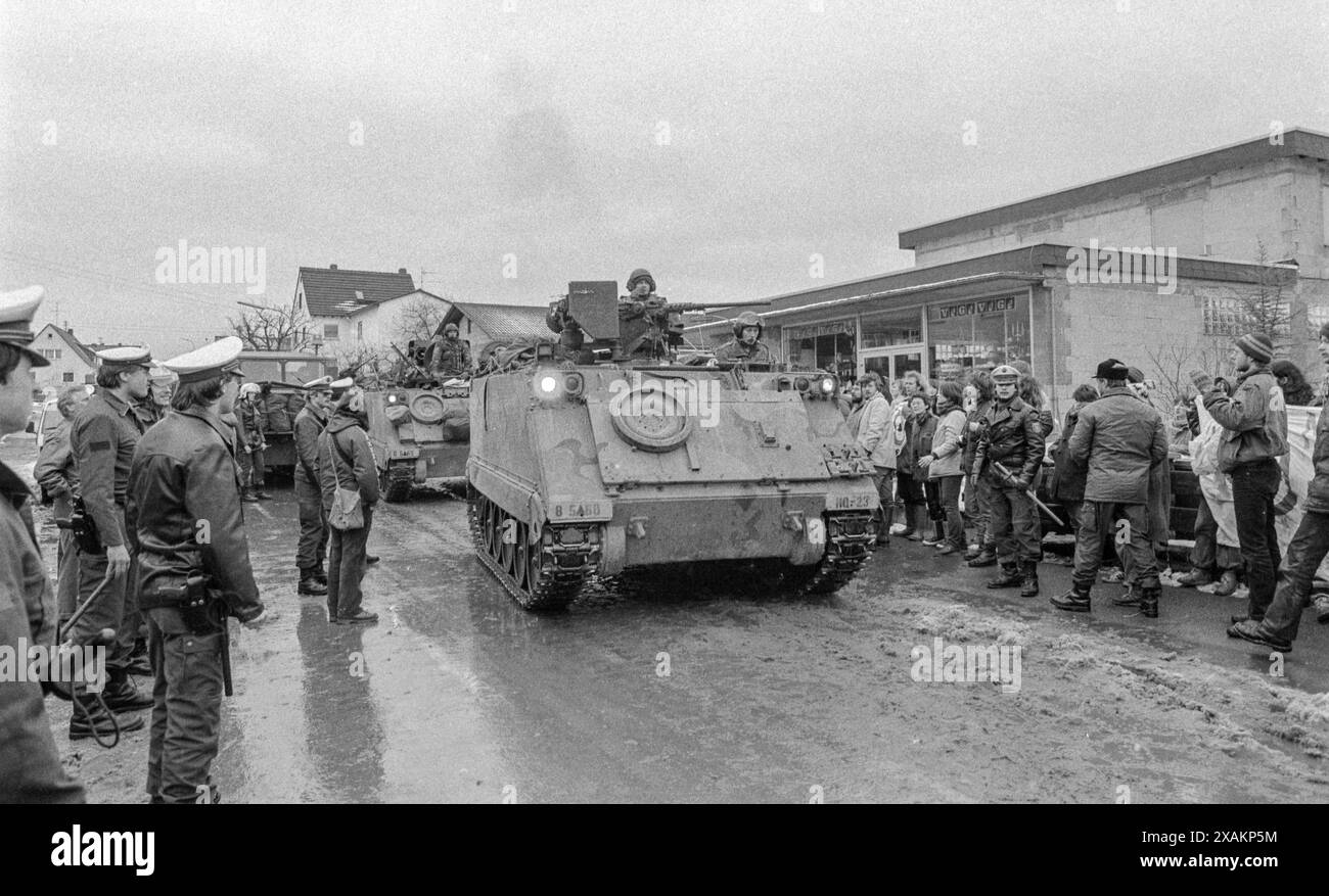 Police accompany a US military maneuver convoy with batons to prevent ...