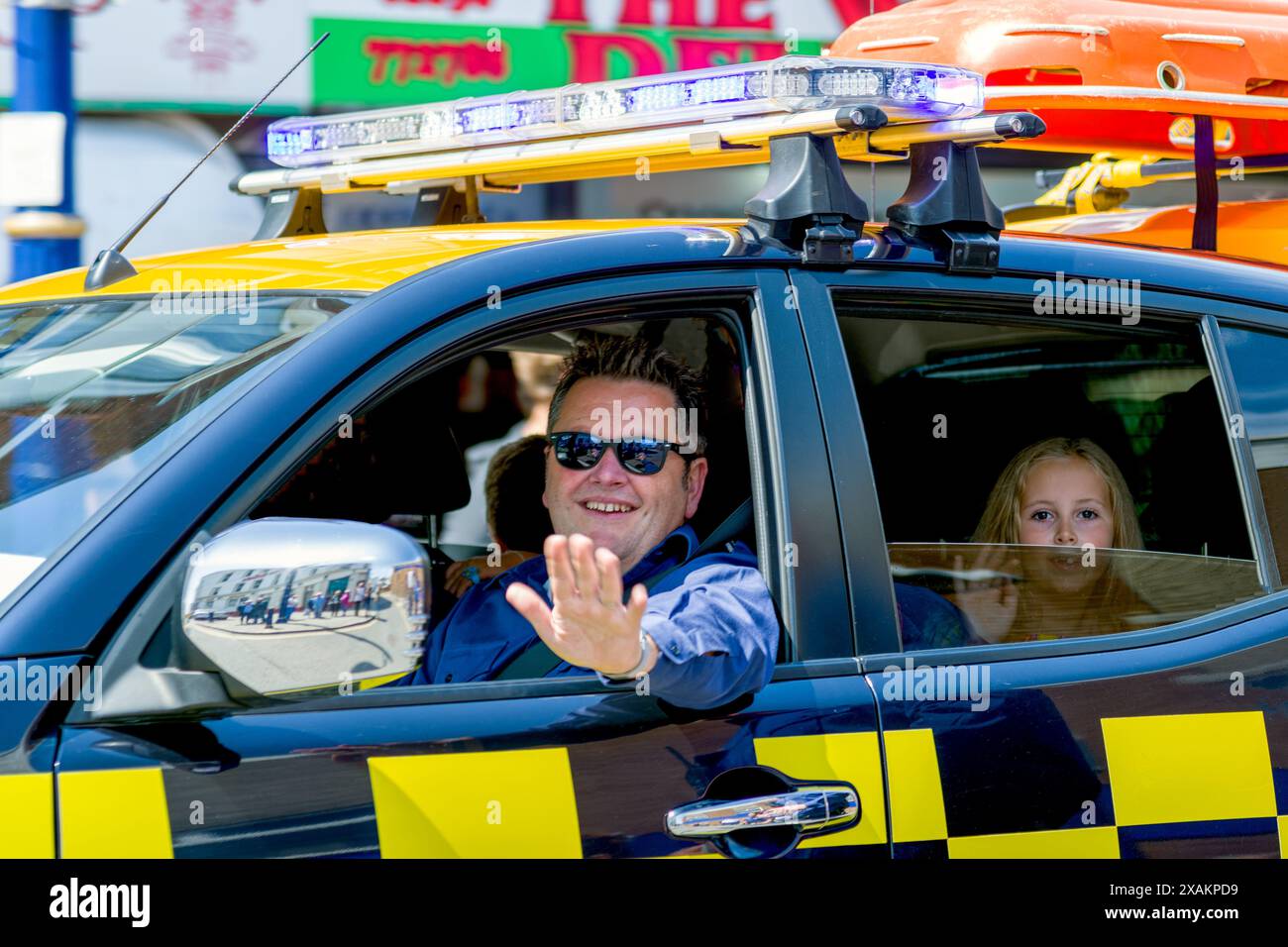A Coastguard vehicle occupants wave to the crowd during the Porthcawl Carnival, 20th July 2019 ...