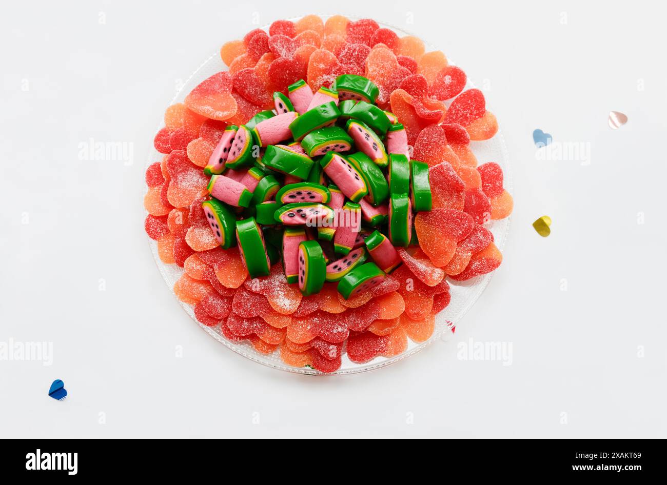 Watermelon-shaped jelly candies on hearts jelly sweets with sugar on a ...