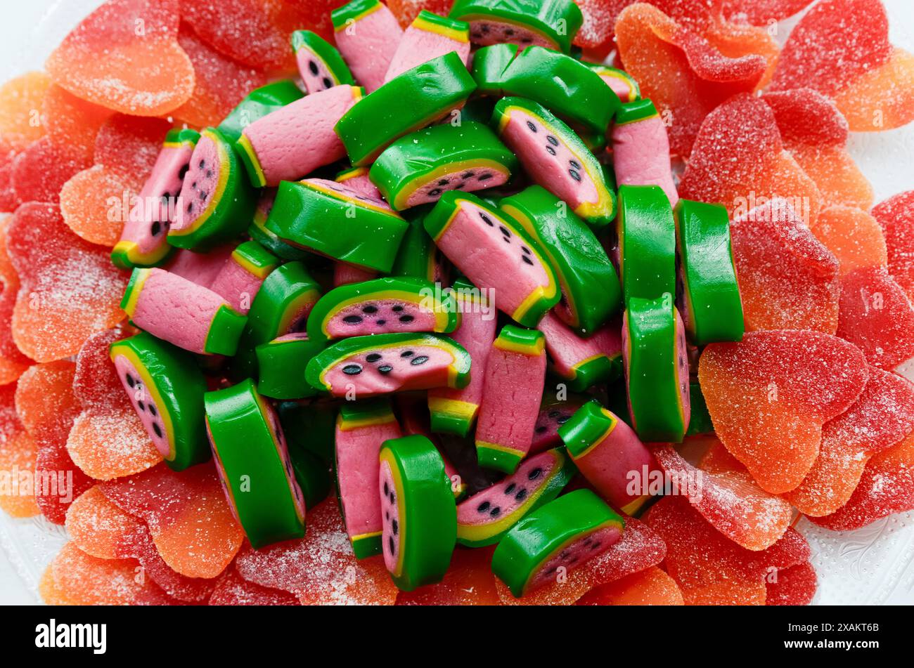 Textured jelly candies shaped like watermelon slices on top of other ...