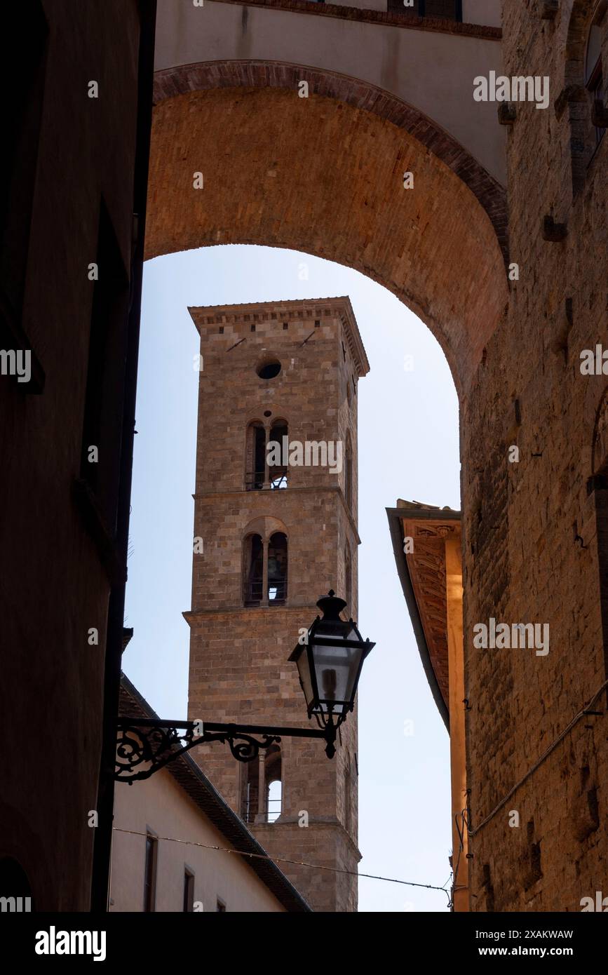 Old Romanesque bell tower of a church in downtown Volterra, Italy Stock ...