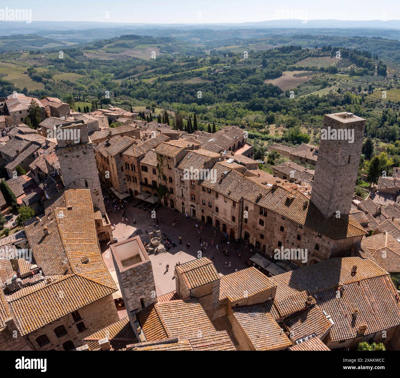 Wide panoramic view over downtown San Gimignano with Torre del Diavolo ...