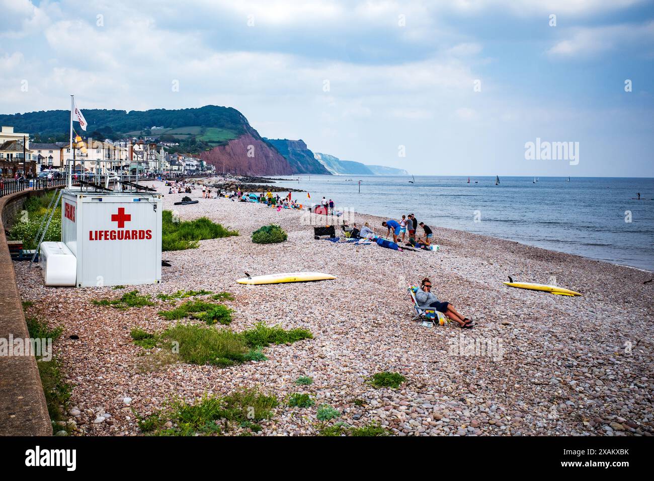 Lifeguard post on Sidmouth beach in early summer. People and surfers on ...