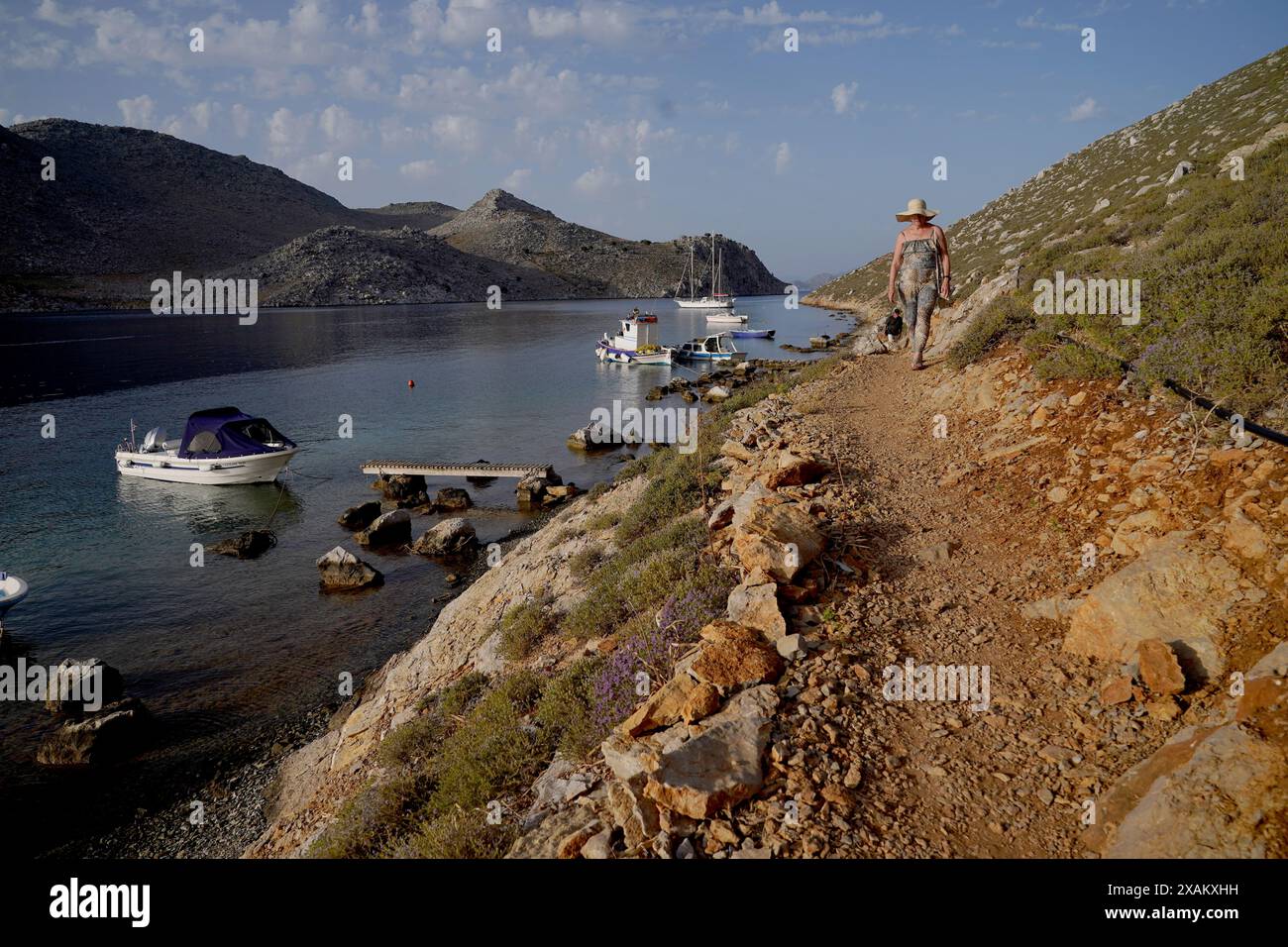 A rocky path near Saint Nikolas Beach in the Pedi district in Symi ...
