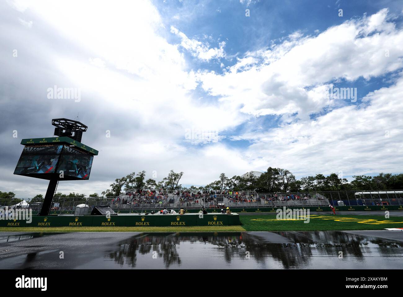 Circuit atmosphere - marshals sweep the circuit of rain water during the first practice session ...