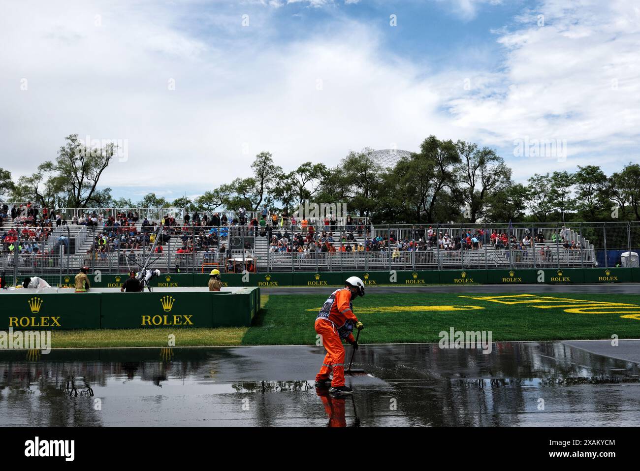 Circuit atmosphere - marshals sweep the circuit of rain water during the first practice session ...