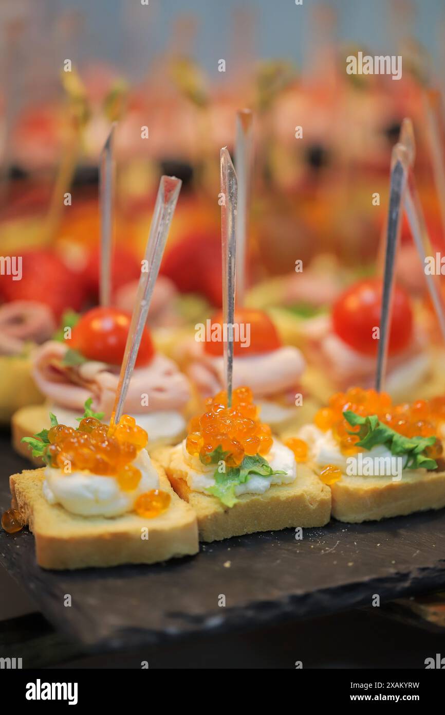 Canapes with red caviar and bread close-up on the festive table Stock ...