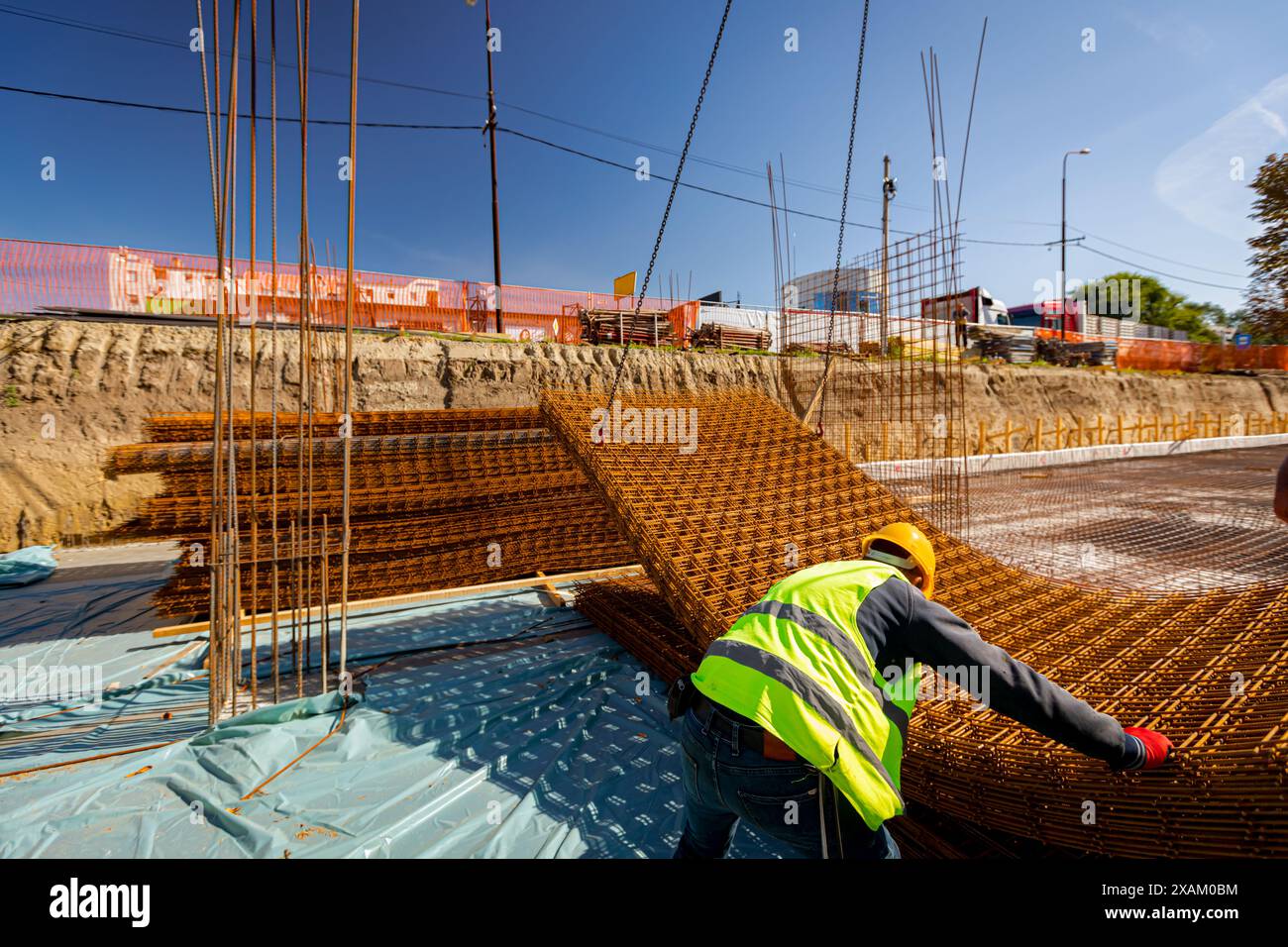 Worker with safety helmet helping crane from the ground, keep balance ...
