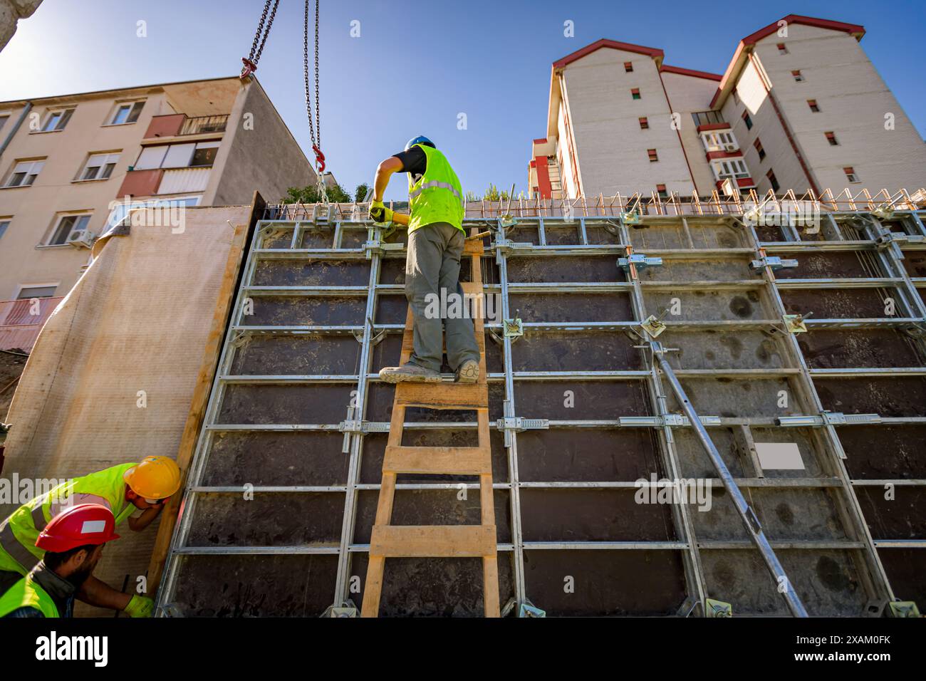 View from behind on construction worker with safety vest and yellow ...