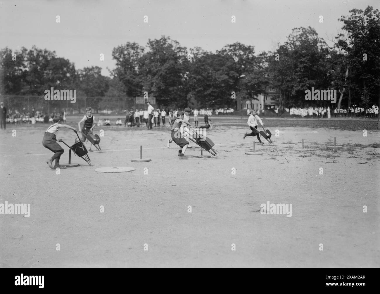Children pushing wheelbarrows hi-res stock photography and images - Alamy
