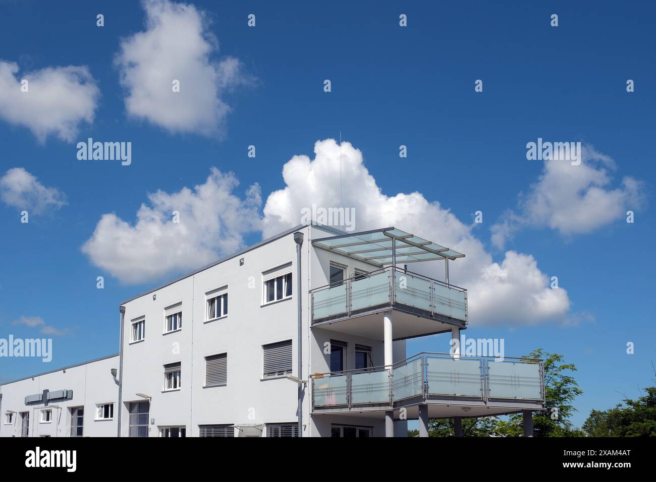 Simple white building architecture and a background with clouds on the ...