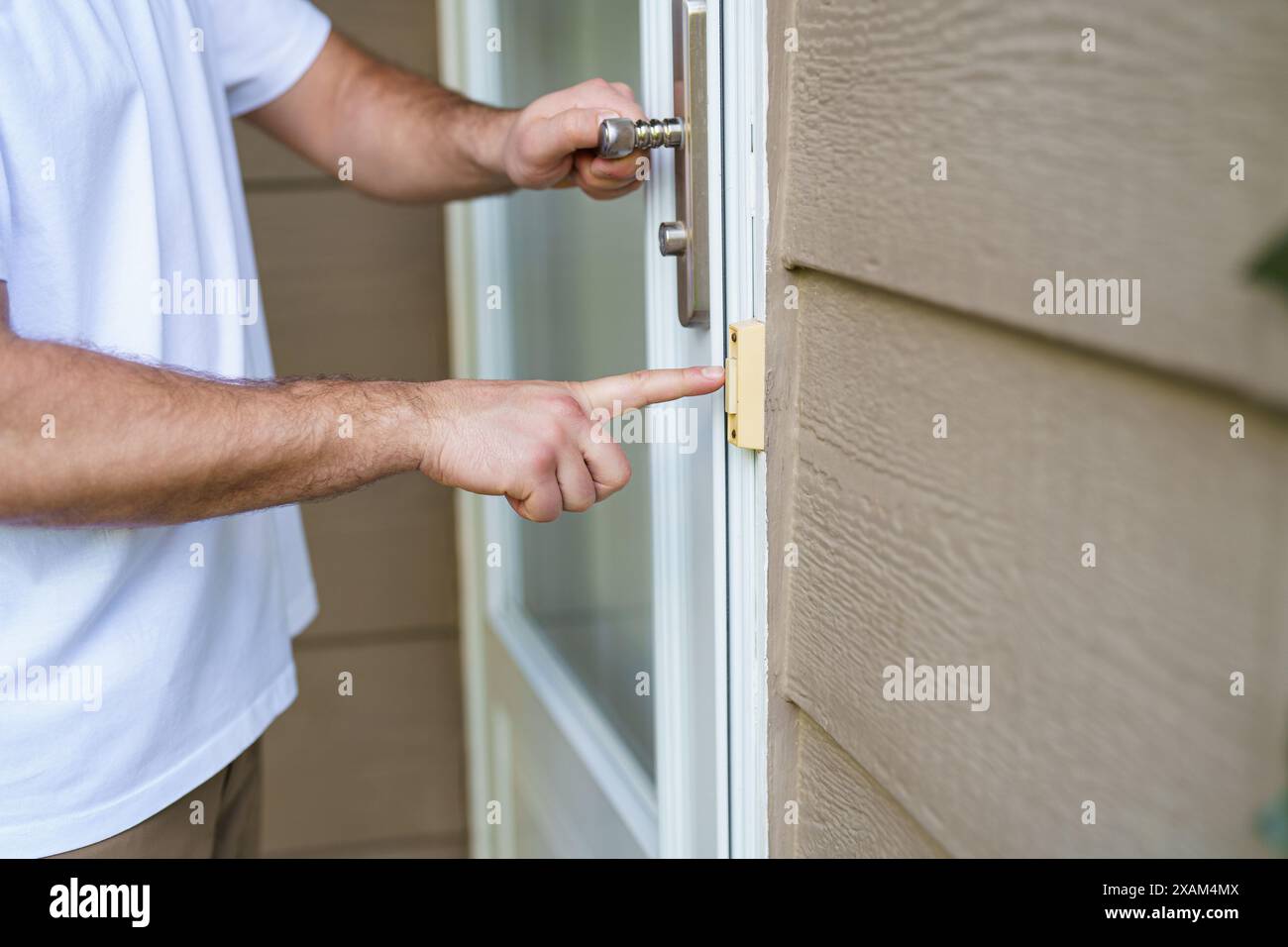 hand ringing on doorbell on pvc front door Stock Photo - Alamy