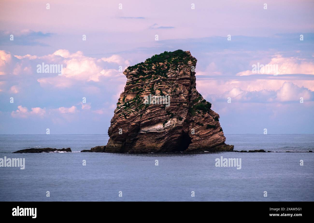 Lonely rock in sea hi-res stock photography and images - Alamy