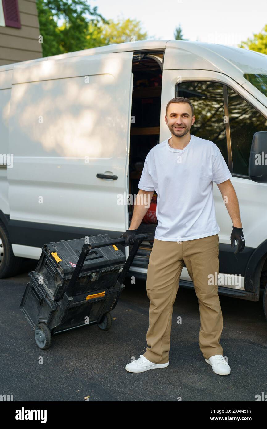 Smiling Caucasian Contractor Worker in his 40s Loading His Tool Boxes ...
