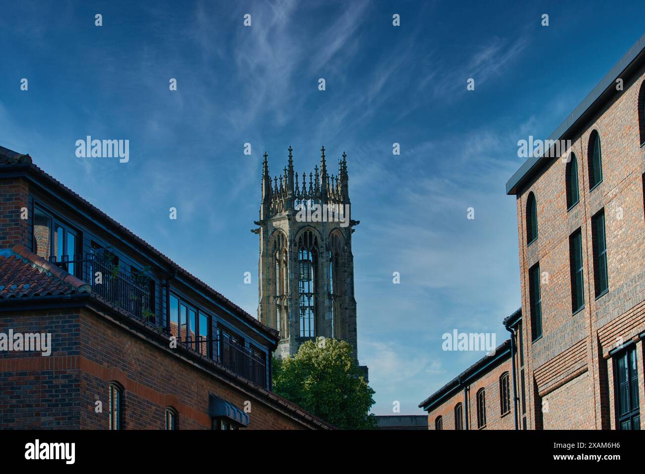 A tall, gothic-style church tower with intricate details, framed by ...