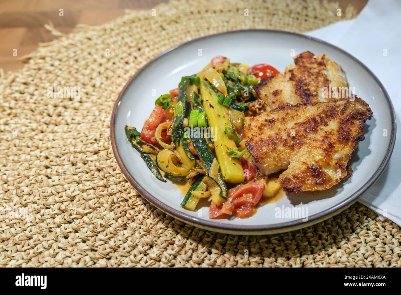Crispy fried redfish fillet on Mediterranean vegetables such as ...