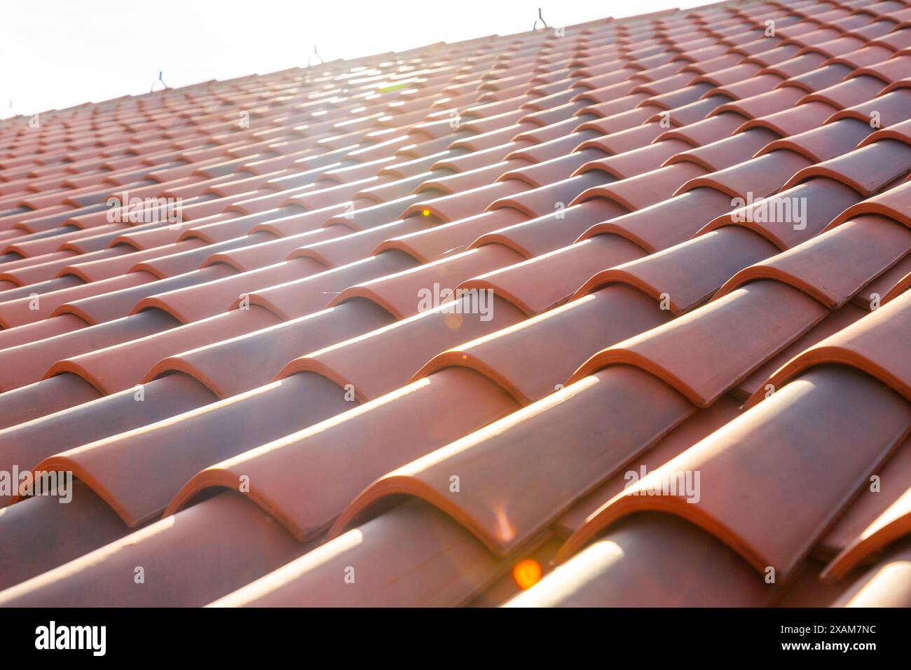 Orange colored classic corrugated roof tiles, shingles, close up ...