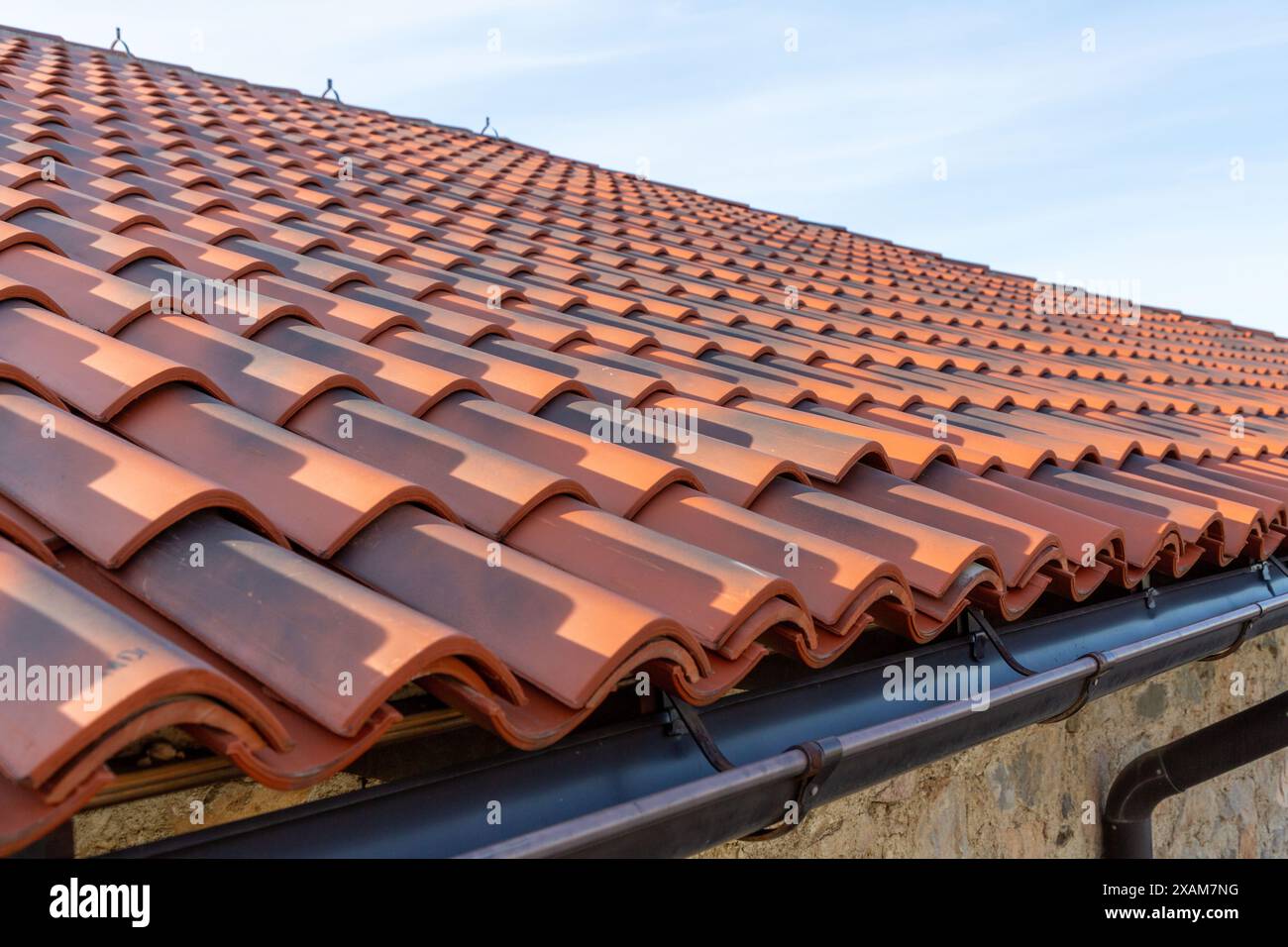 Orange colored classic corrugated roof tiles, shingles, close up ...