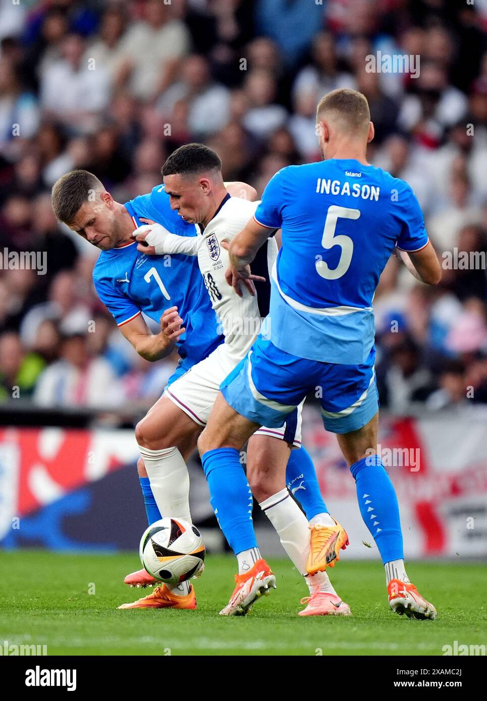 England’s Phil Foden (centre) is tackled by Iceland's Johann Berg ...