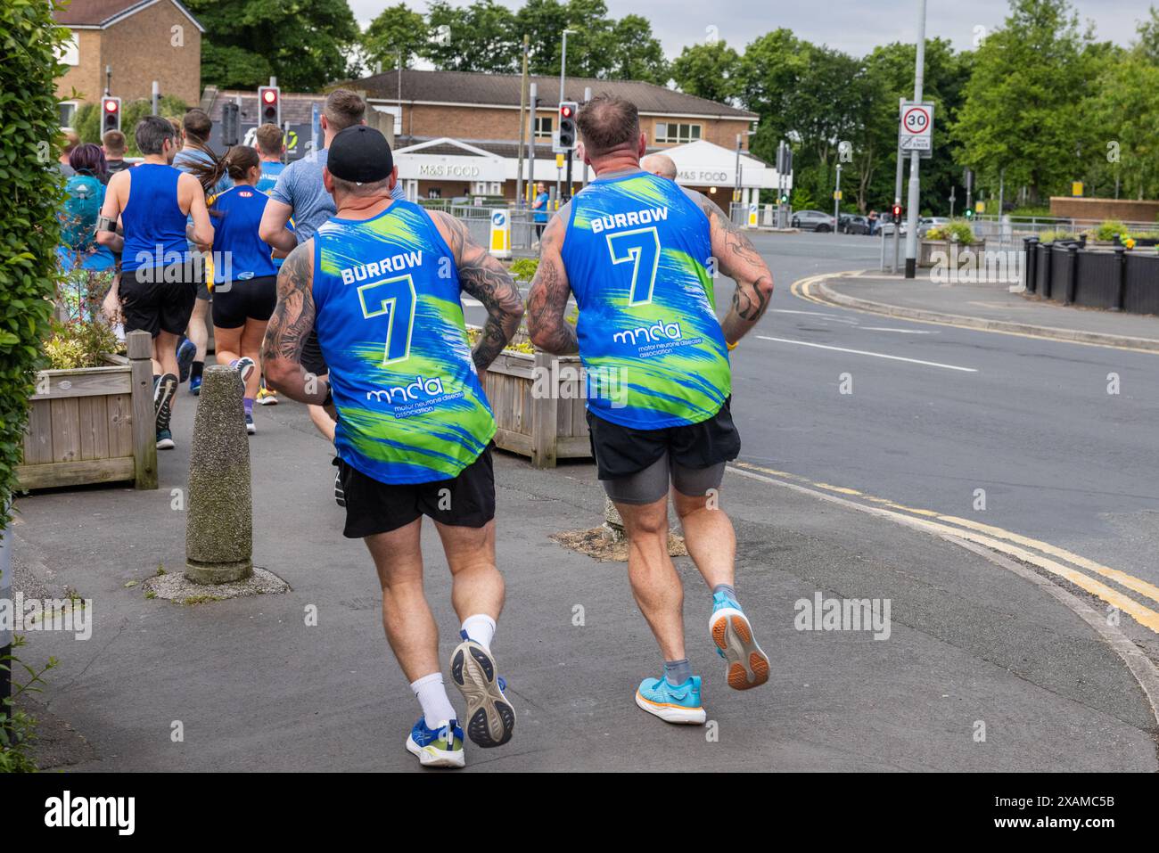 Leeds, UK. 07 JUN, 2024. Two people in Rob Burrow shirts run through ...