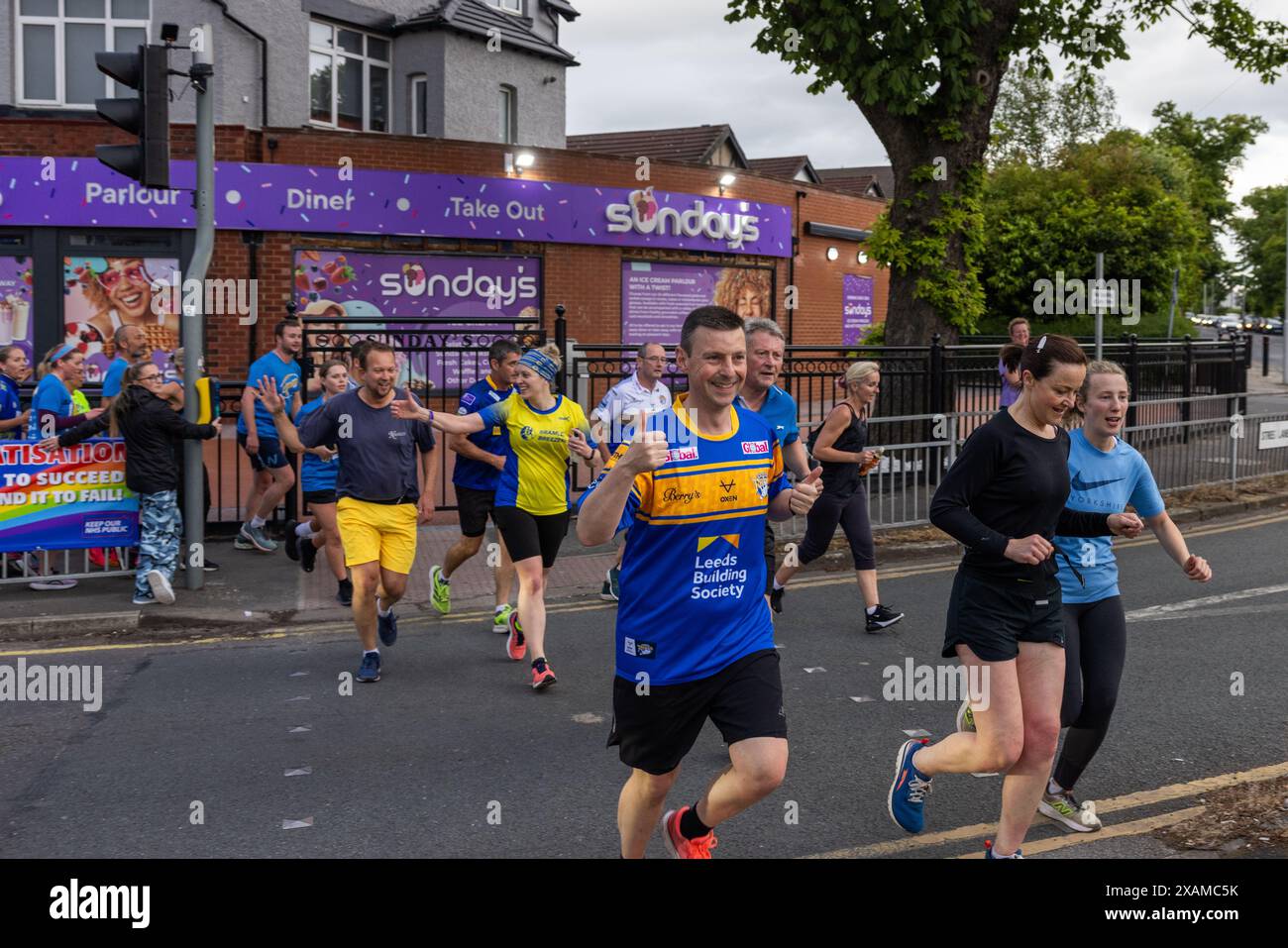 Leeds, UK. 07 JUN, 2024. Runners make their way through moortown as ...