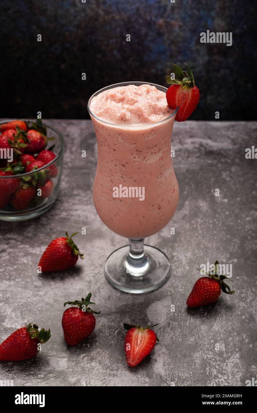 Strawberry milkshake on cement table with dark background. Strawberry ...