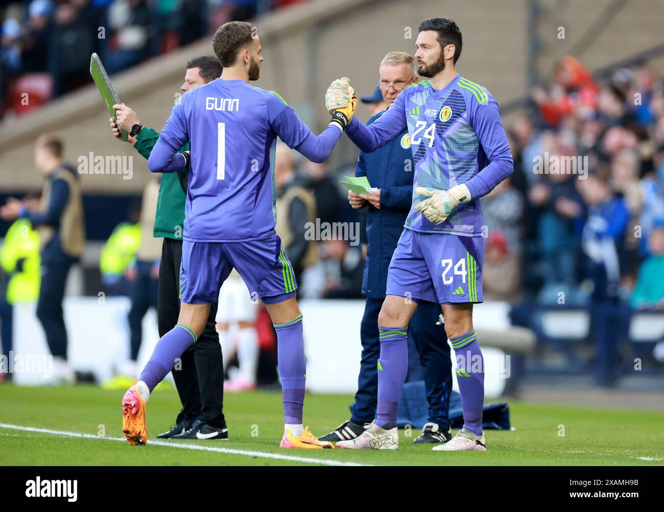 Scotland goalkeeper Angus Gunn (left) is substituted off for team-mate ...
