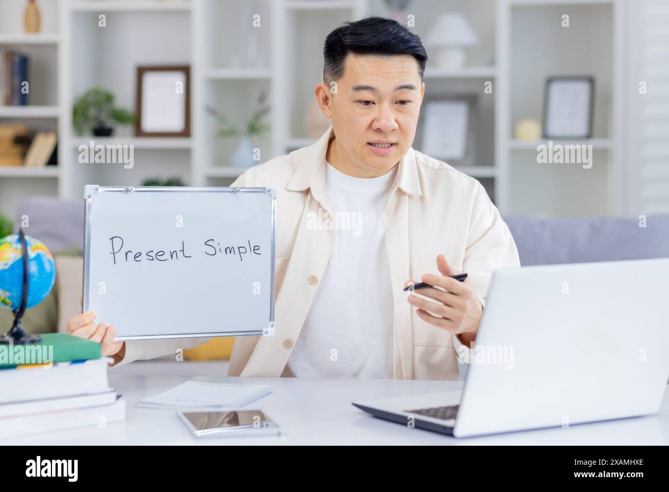 Online English teacher explaining present simple tense during a virtual ...