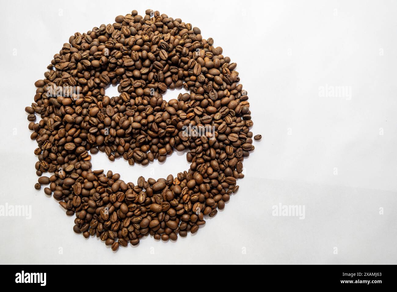 Creative arrangement of coffee beans forms a cheerful smiley face ...