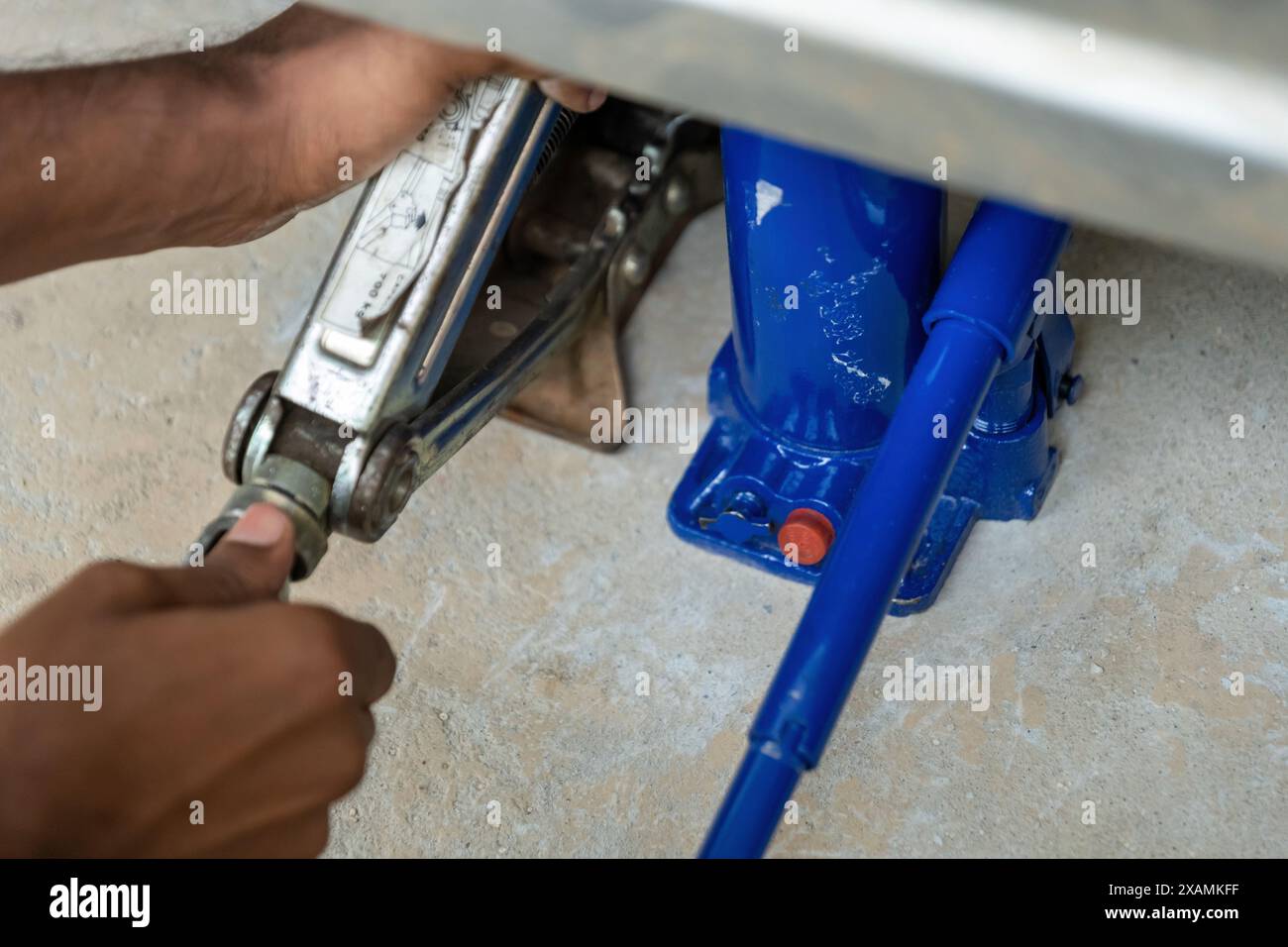Hands-on car maintenance using a bottle jack and scissor jack ...