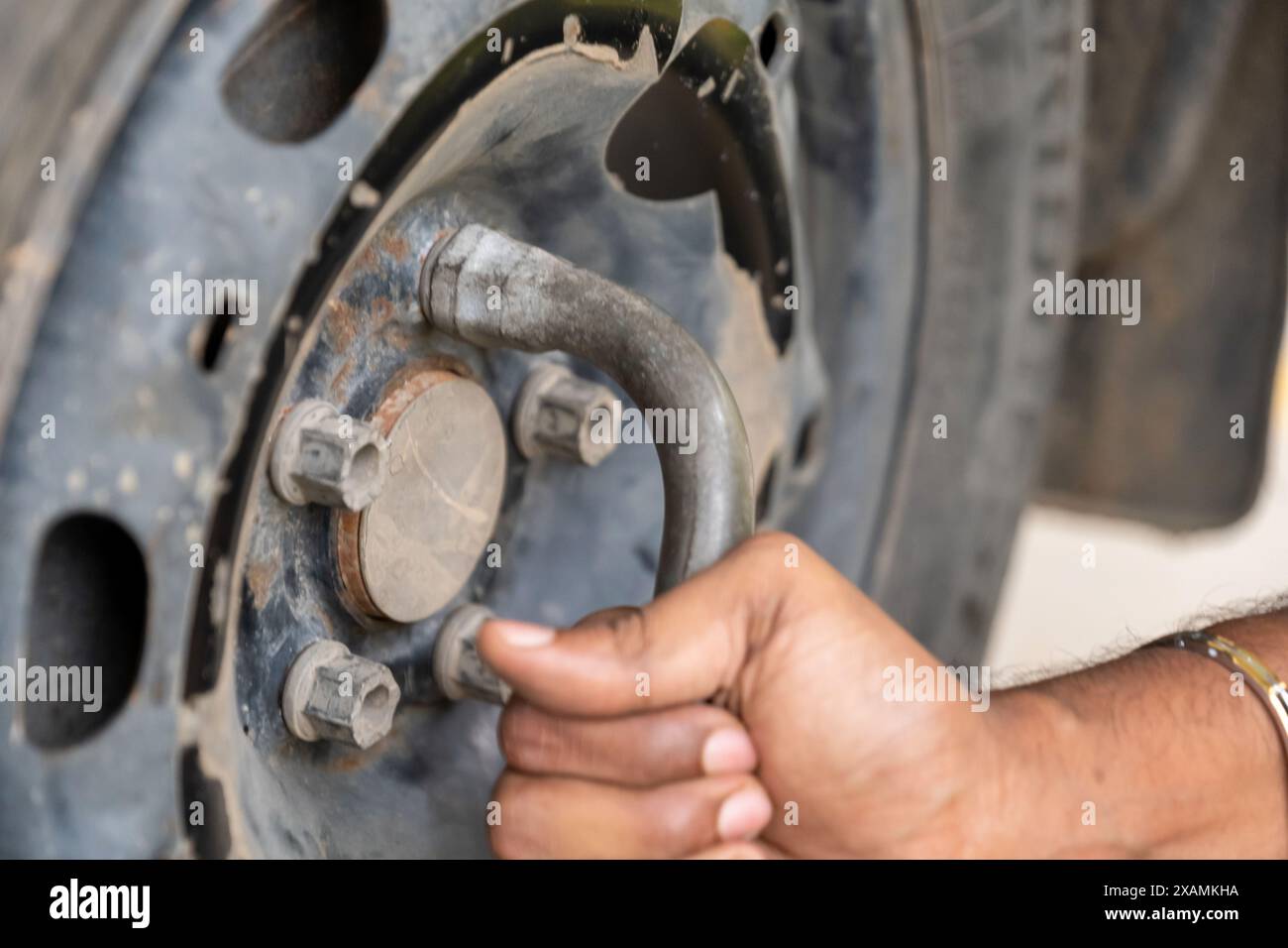 Close-up view of a mechanic deftly removing a car tyre using ...