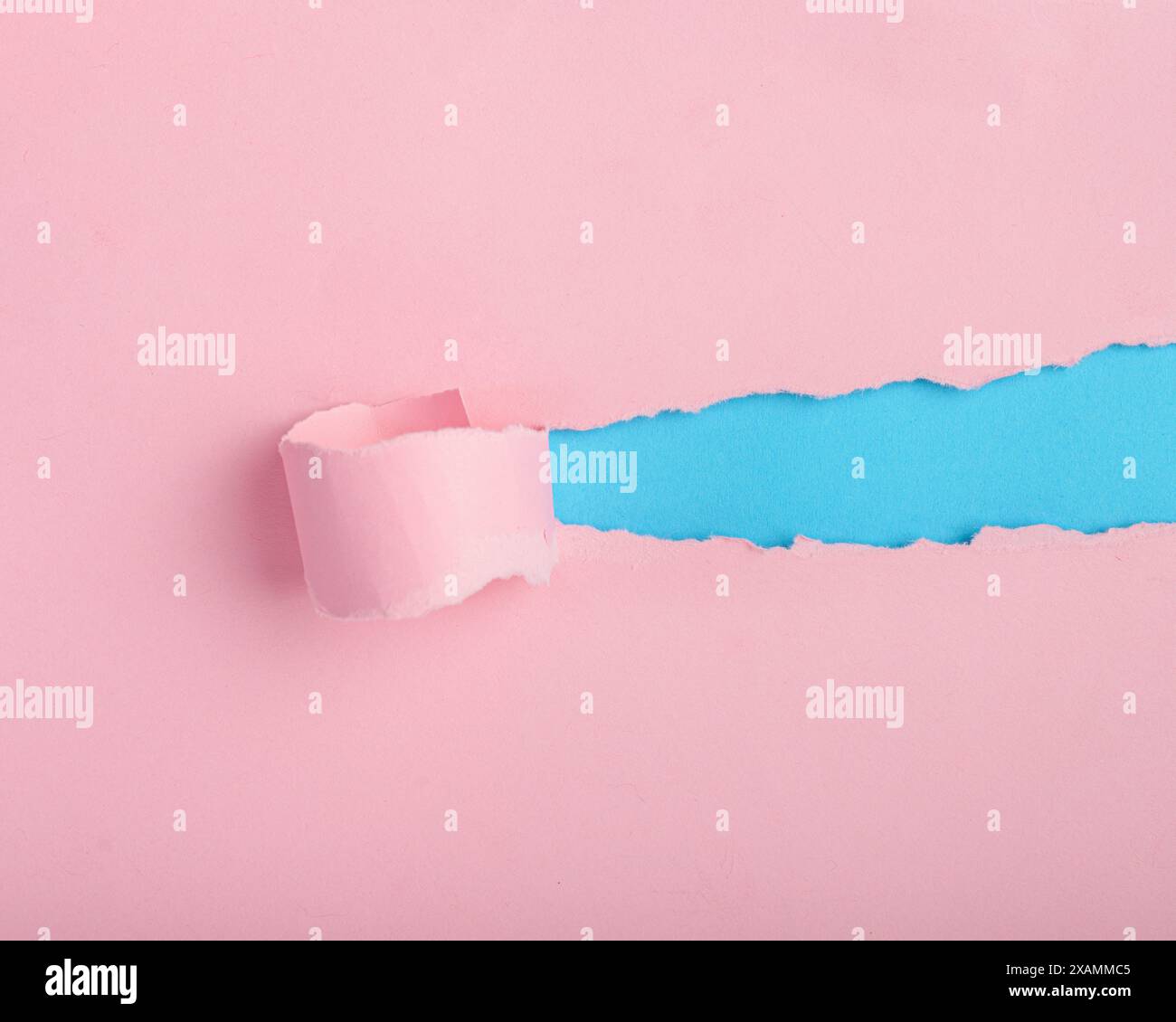 Torn pink paper revealing blue background. Background, paper texture ...