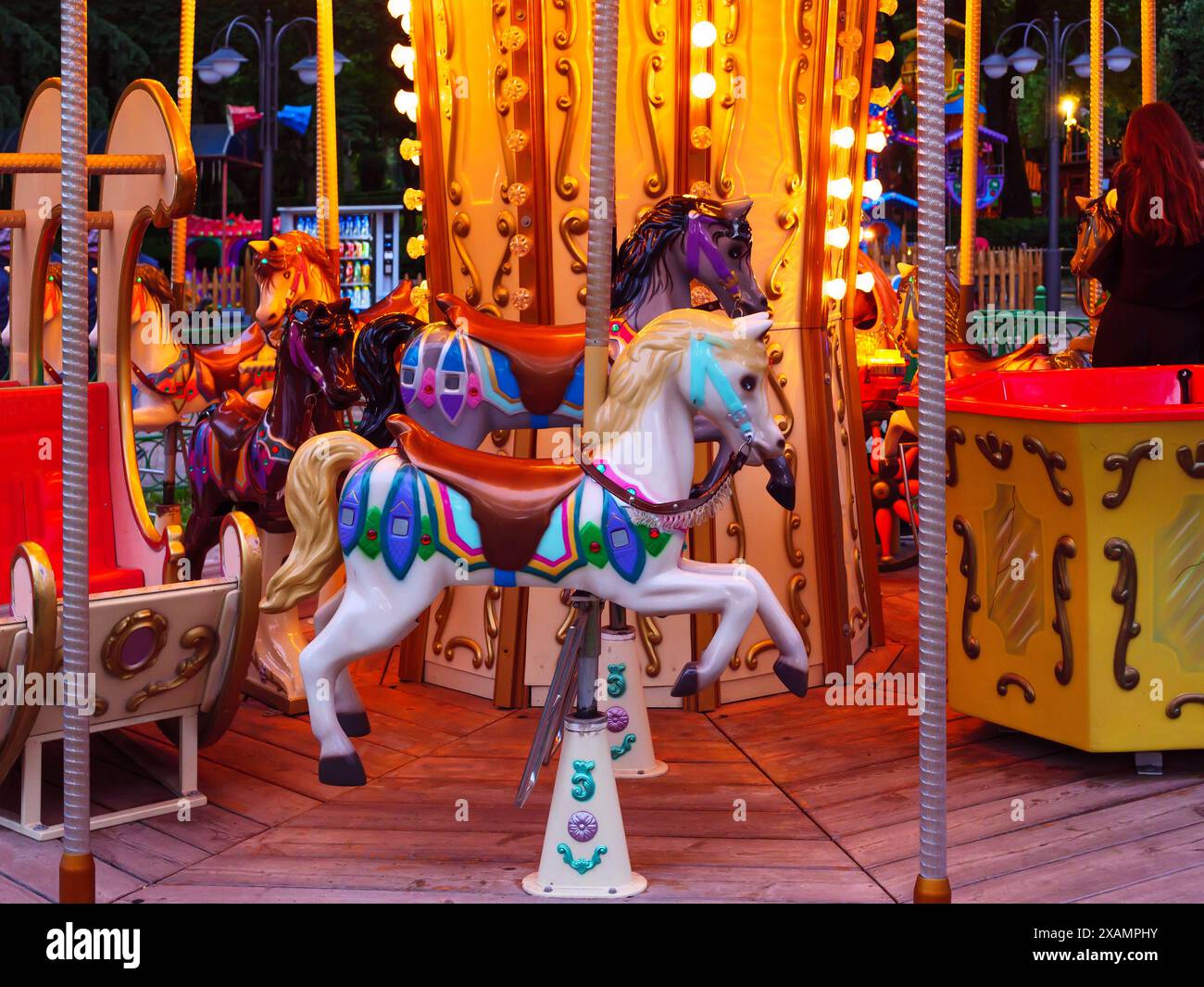A close-up view of painted carousel horses, with vibrant colors and ...