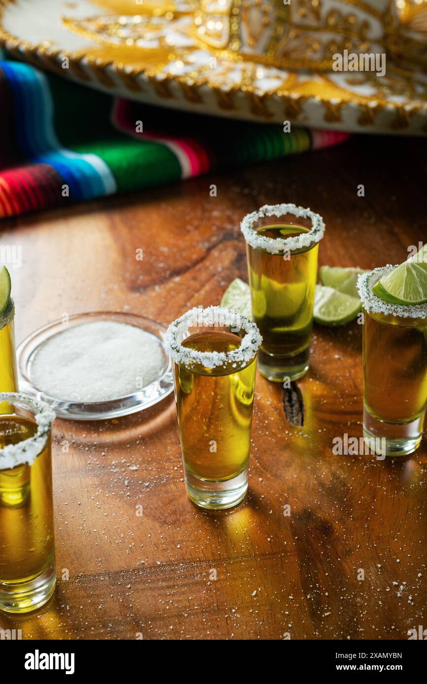 Shots of tequila with salt and lemon on a wooden table. Festive ...
