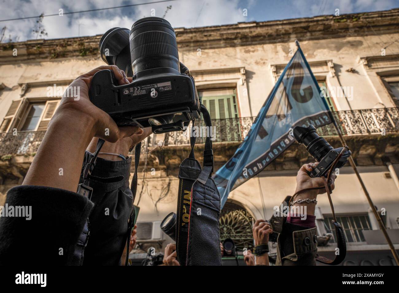 Photojournalists raise their cameras during the protest. Act for the ...