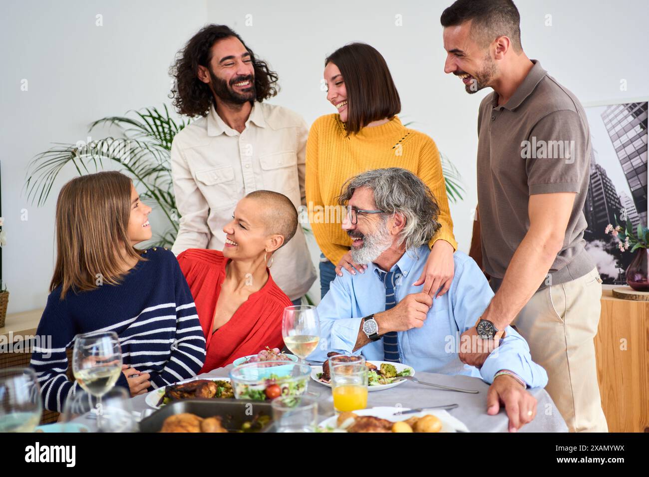Joyful Caucasian family smiling looking at each other hugging and ...