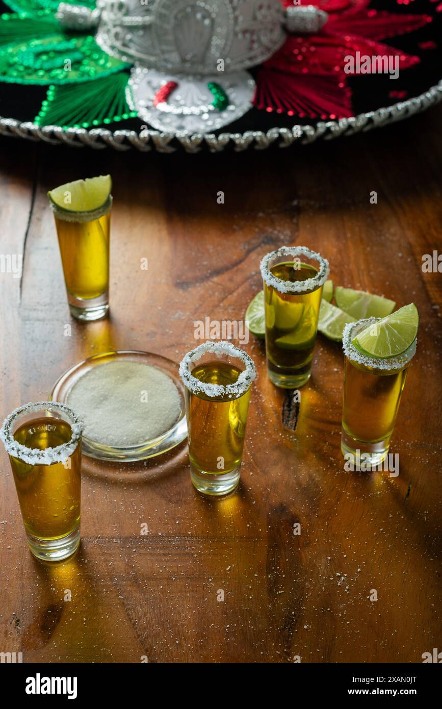 Shots of tequila with salt and lemon on a wooden table. Festive ...