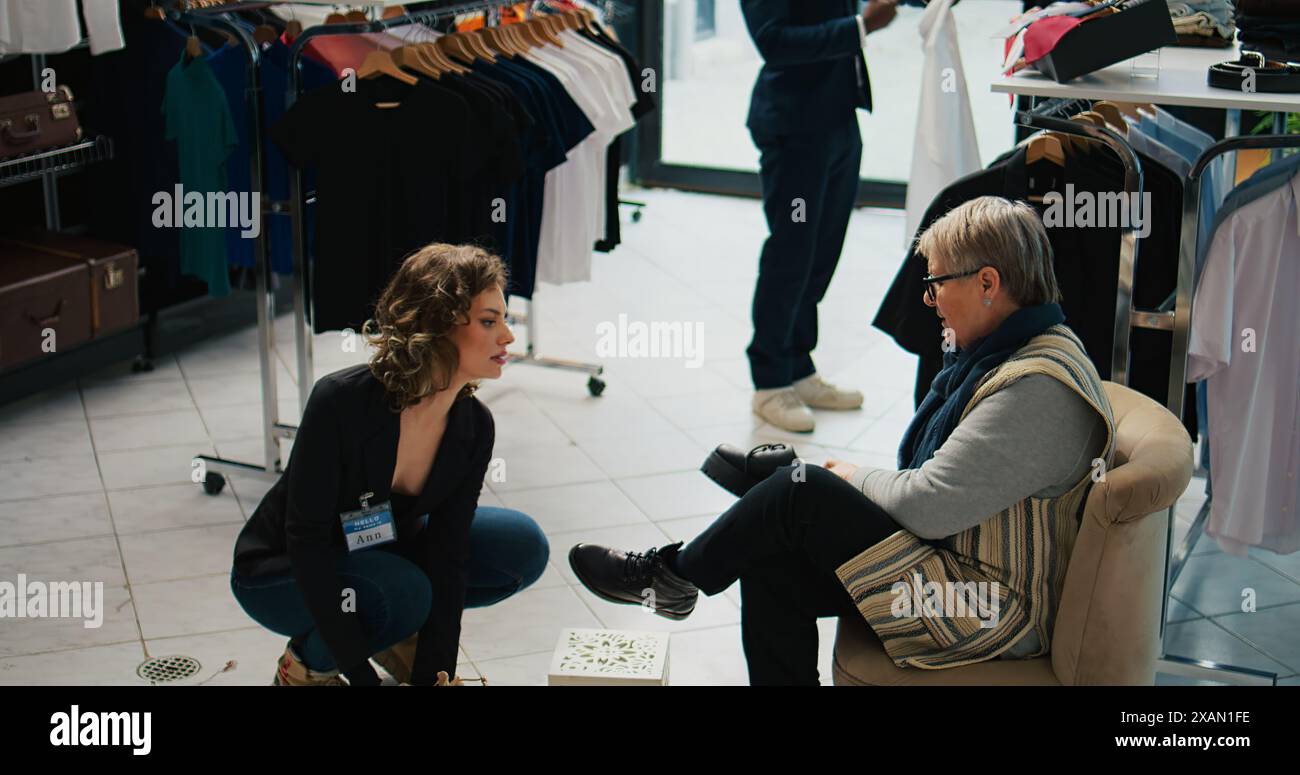 Elderly woman searching for a comfortable pair of shoes at mall, asking ...