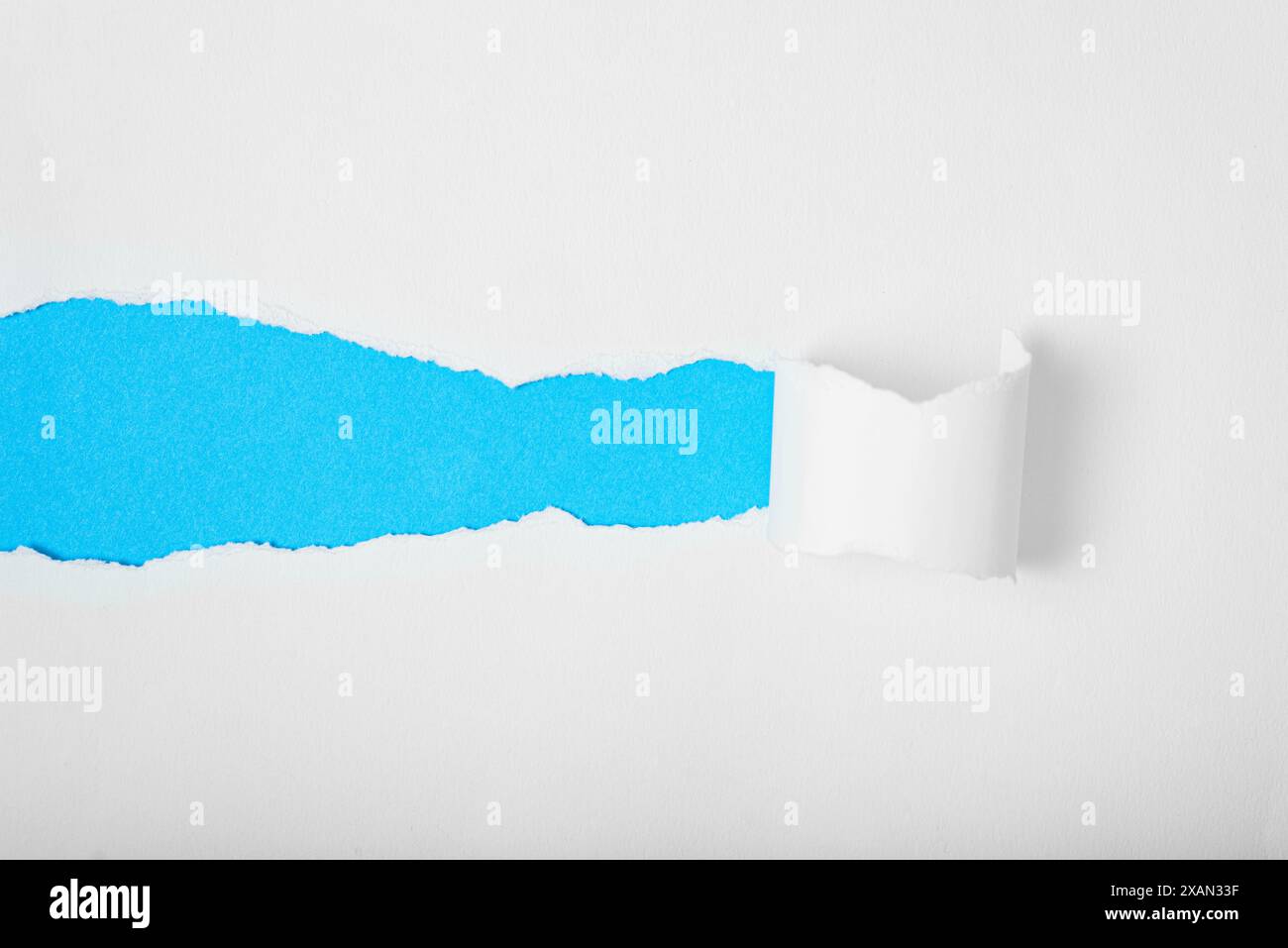 Torn white paper revealing blue background. Space for text Stock Photo - Alamy