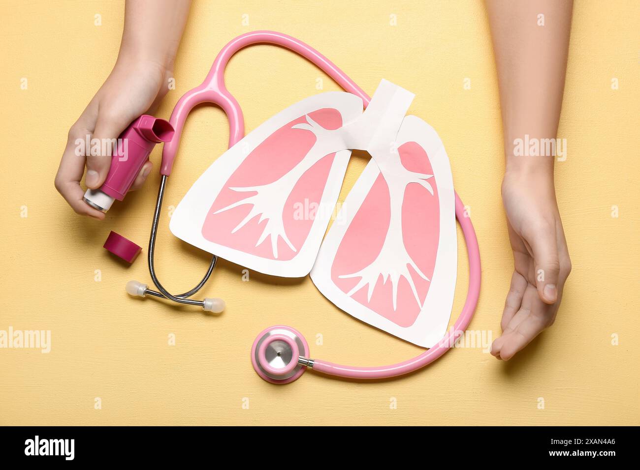 Female hands with asthma inhaler, paper lungs and stethoscope on yellow ...