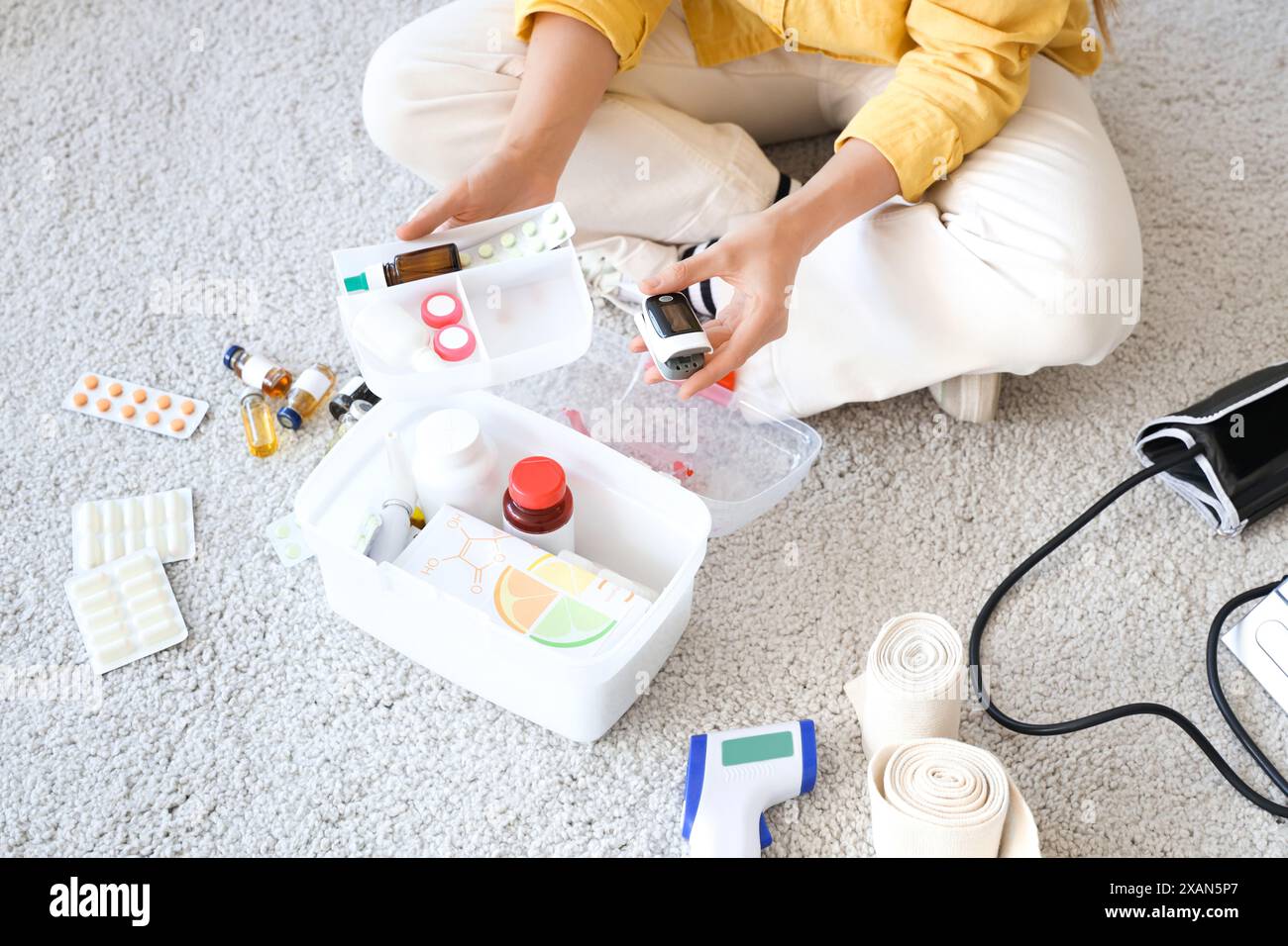 Woman packing first aid kit at home, top view Stock Photo - Alamy