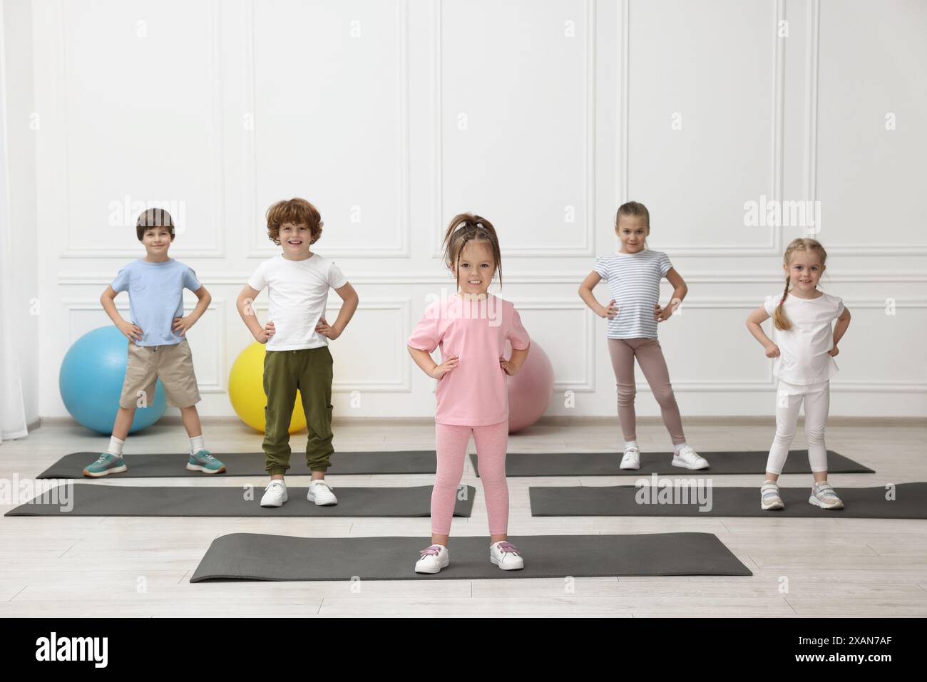 Group of children doing gymnastic exercises on mats indoors Stock Photo ...