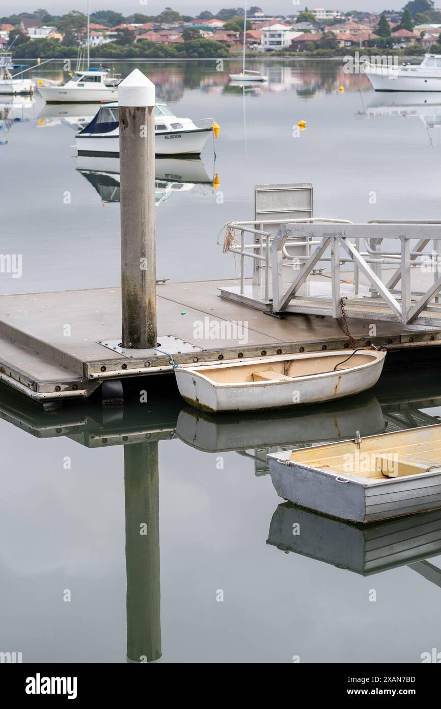 Row boat on calm still lake with boat's reflection on water Stock Photo ...