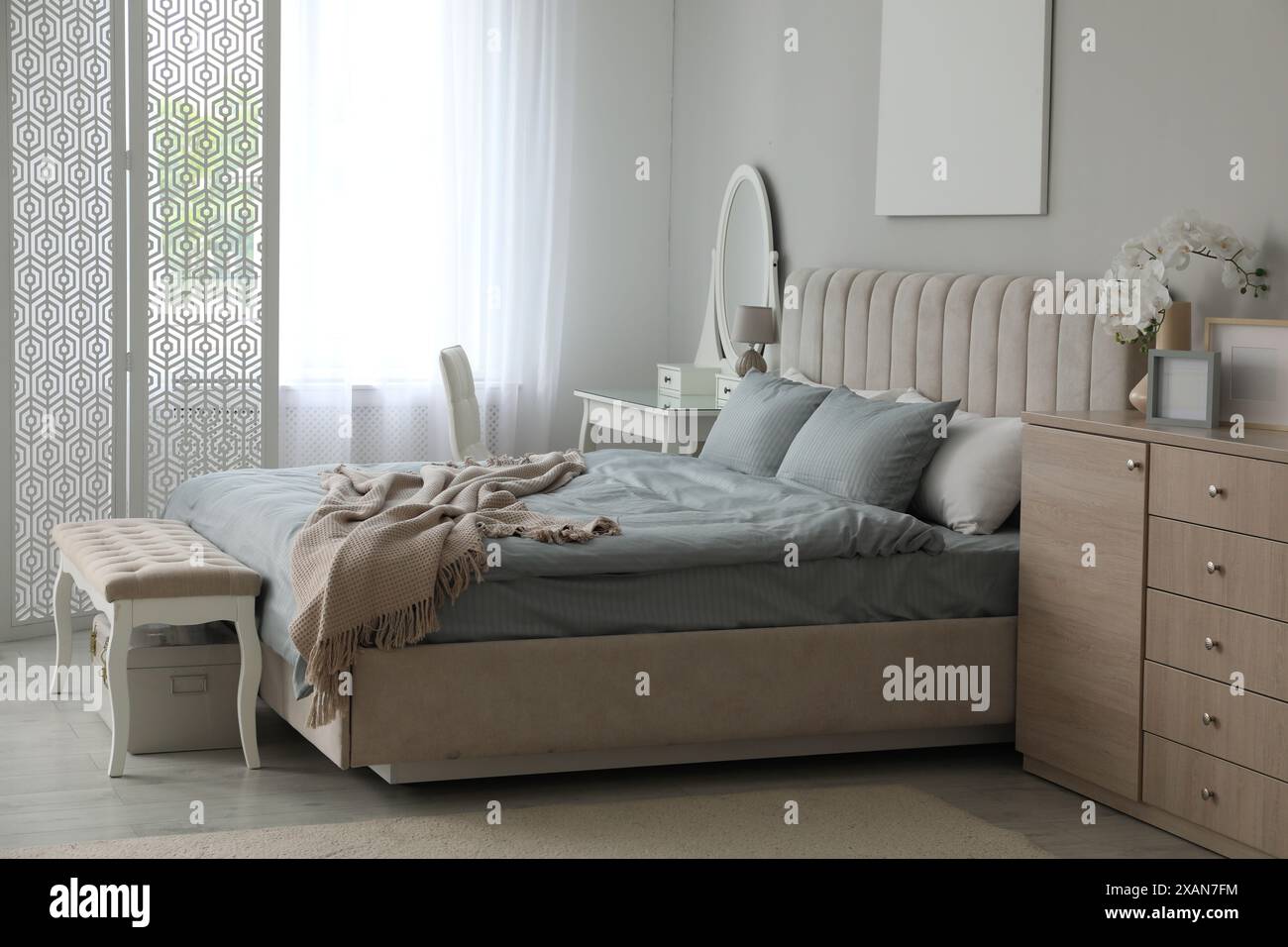 Folding screen, mirror and comfortable bed in bedroom. Interior design ...