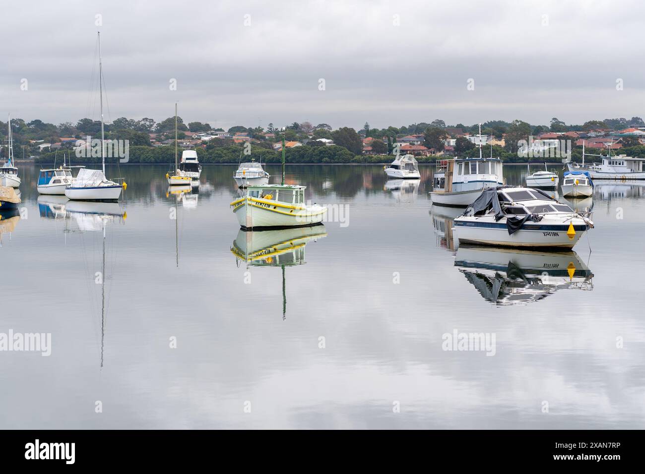 Row boat on calm still lake with boat's reflection on water Stock Photo ...