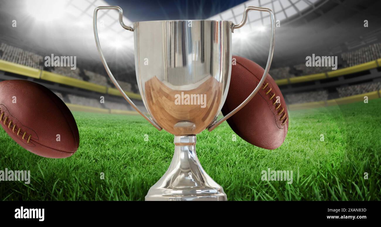 Image of silver cup with rugby balls in rugby field sports stadium ...